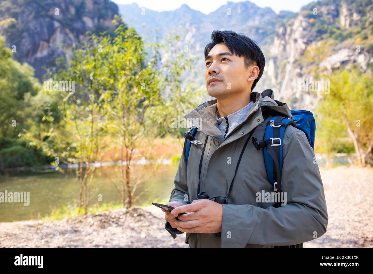 Young Chinese man hiking outdoors Stock Photo - Alamy