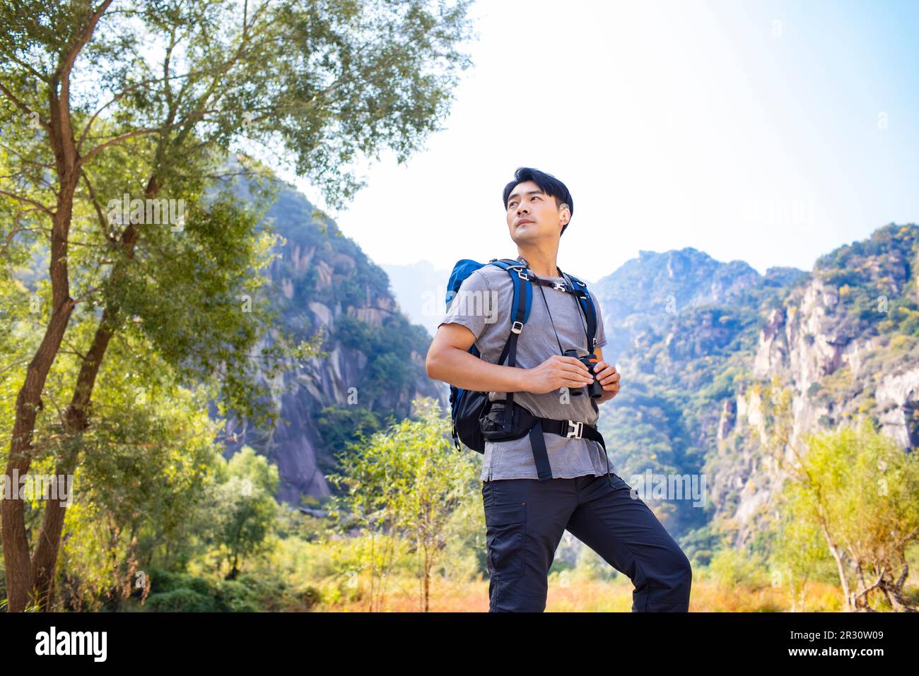 Young Chinese man hiking outdoors Stock Photo - Alamy