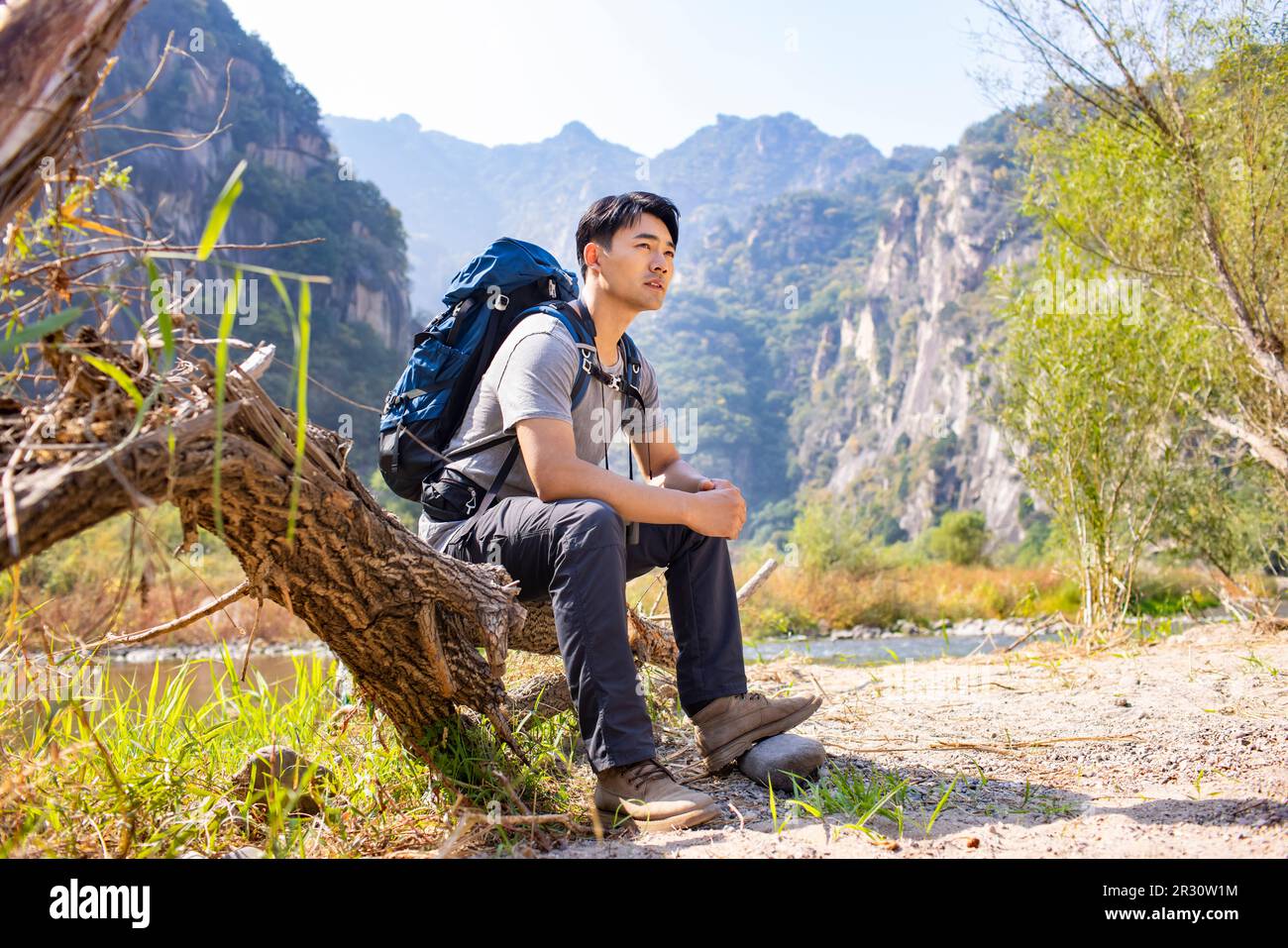 Young Chinese man hiking outdoors Stock Photo - Alamy