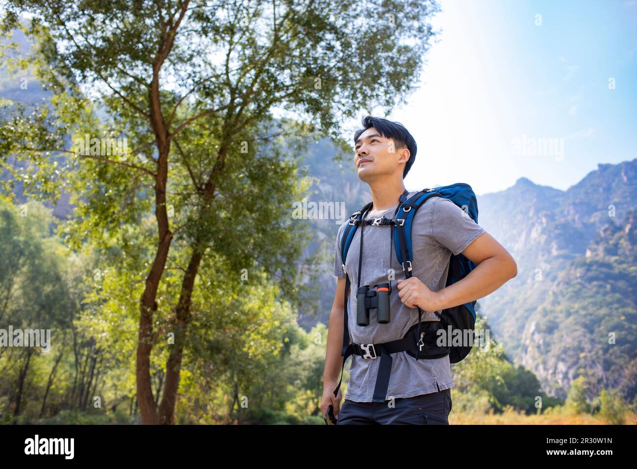 Young Chinese man hiking outdoors Stock Photo - Alamy