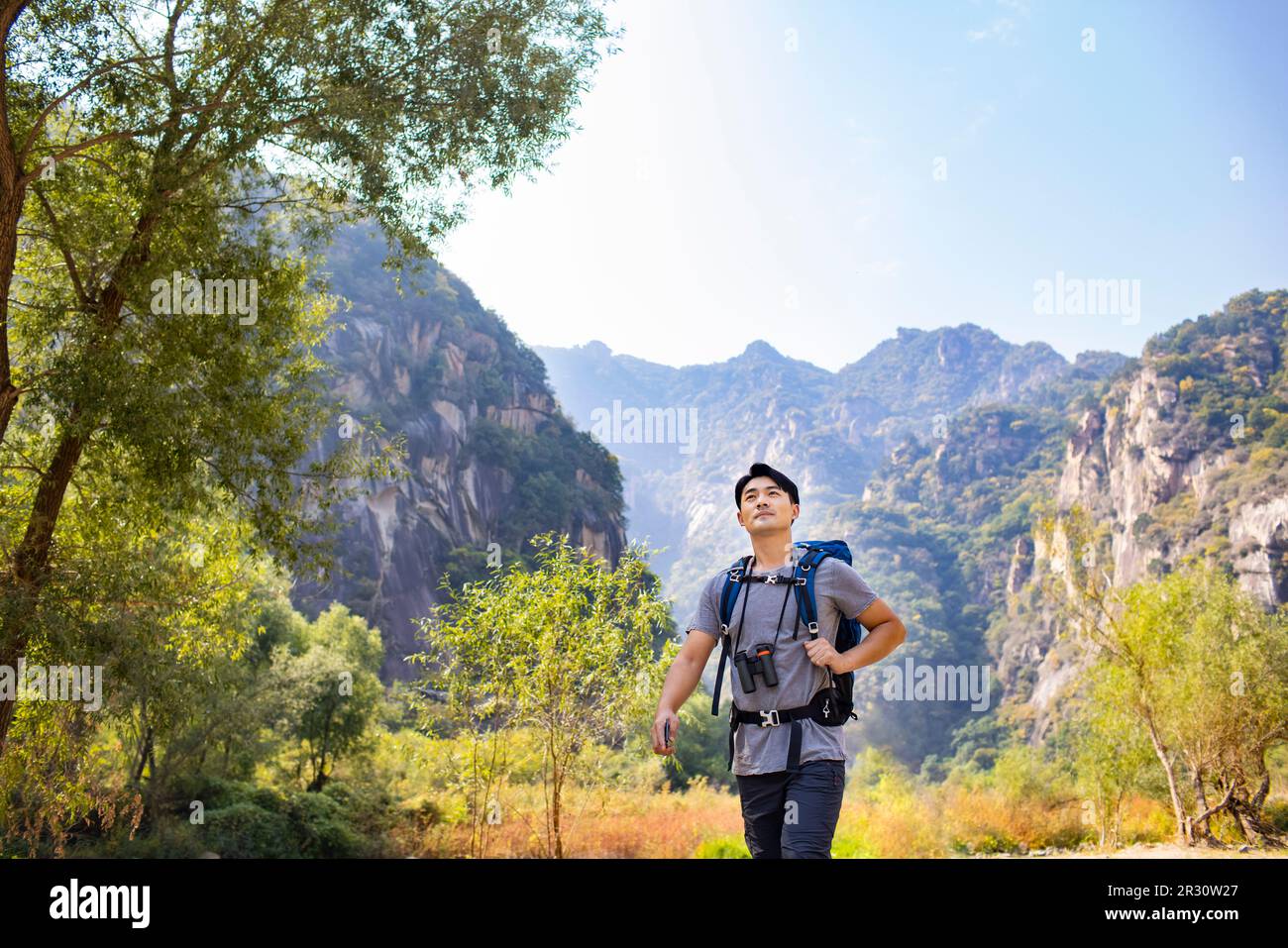 Young Chinese man hiking outdoors Stock Photo - Alamy