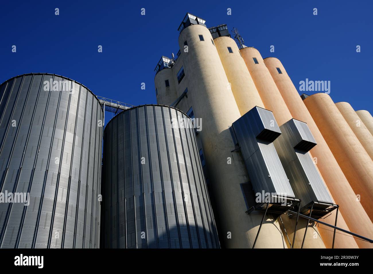 Steel and Concrete Grain Silos From Ground Against Blue Sky Stock Photo ...