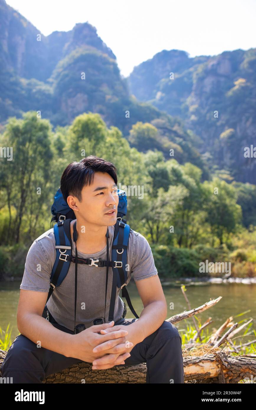 Young Chinese man hiking outdoors Stock Photo - Alamy