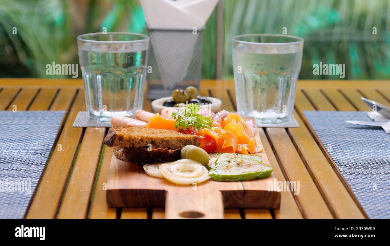 Rustic wooden cutting board displays a variety of cold cuts Stock Photo ...