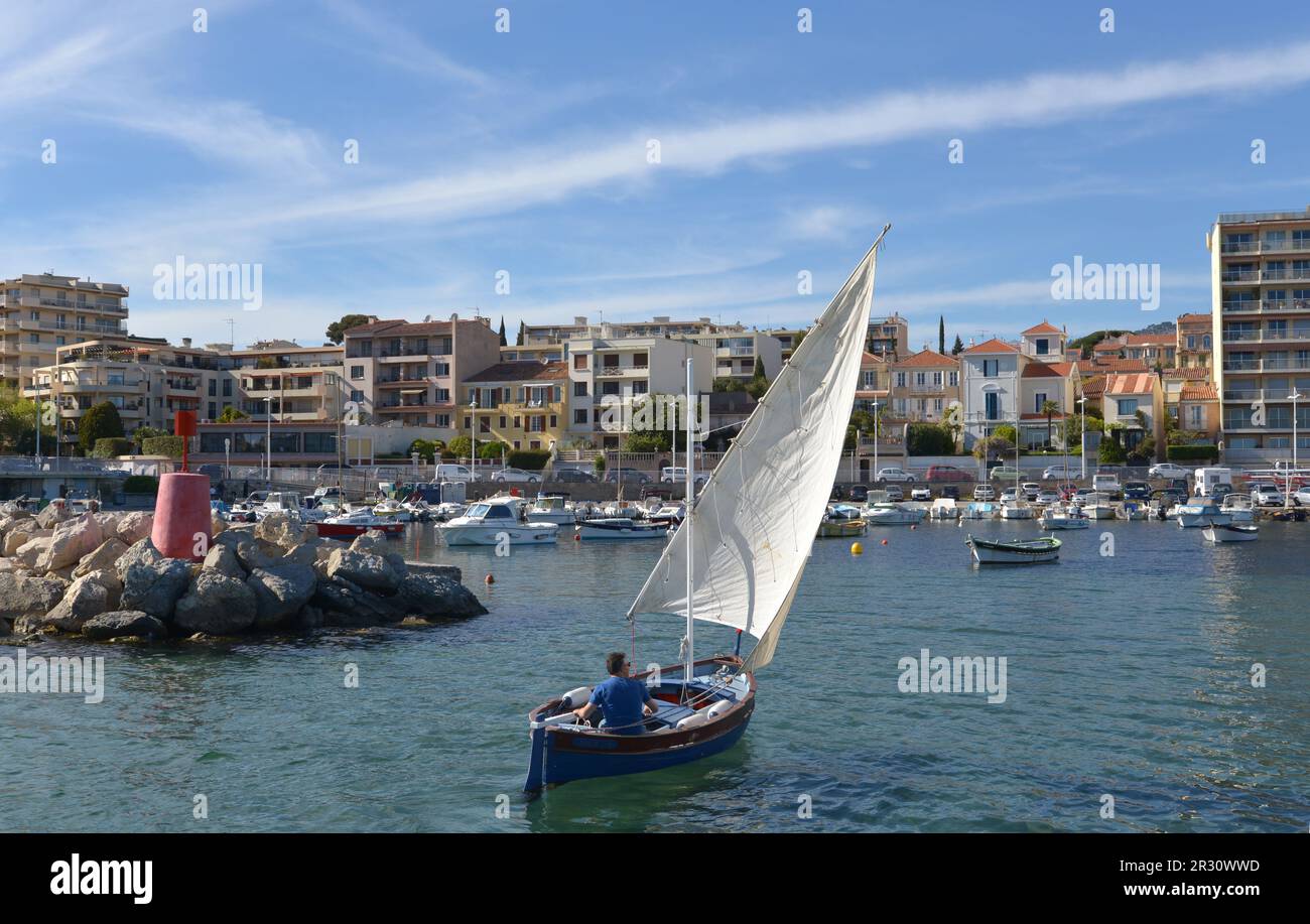 Traditional Provencal boat entering under sail at the small port of St ...