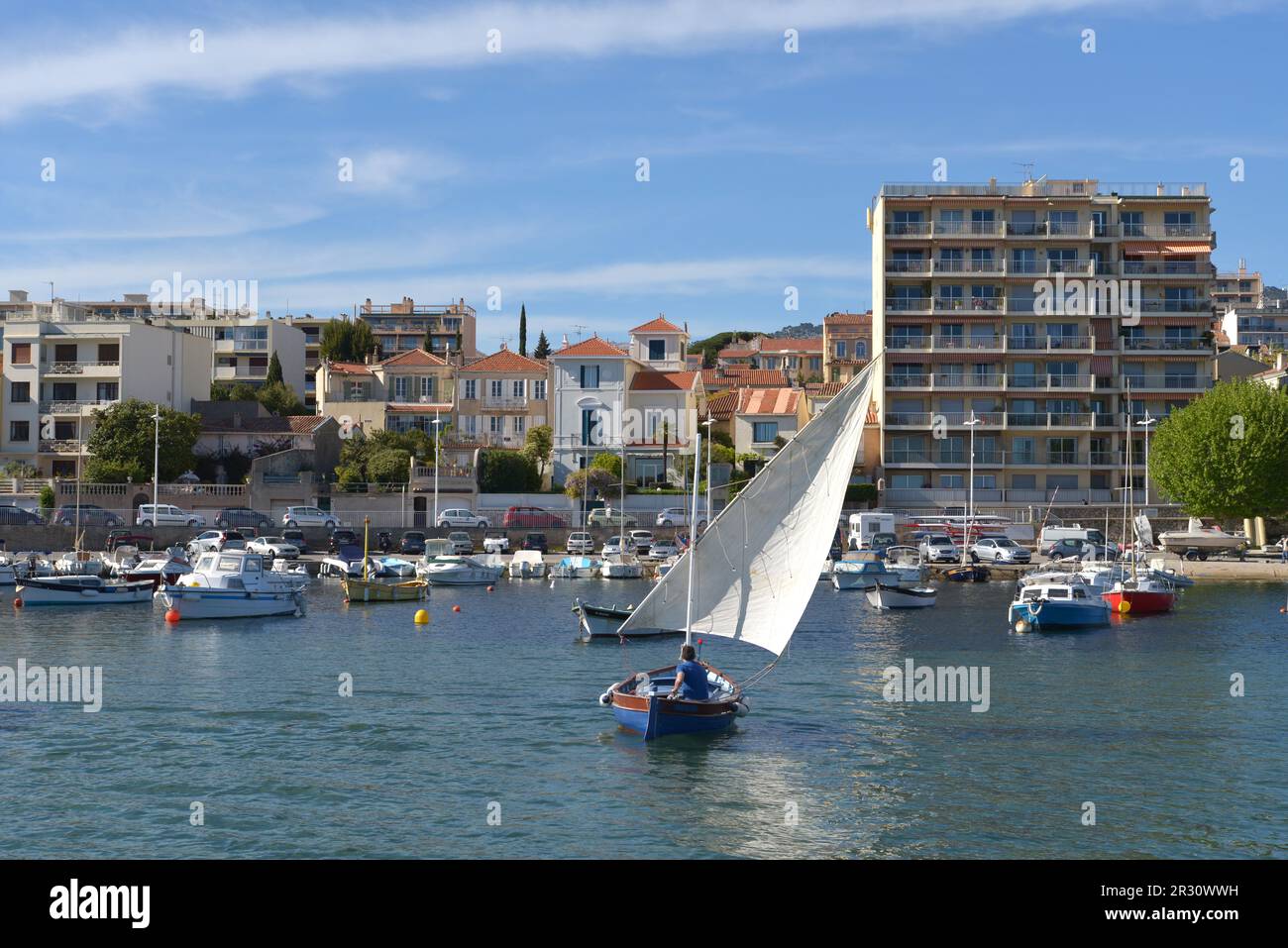 Traditional Provencal boat entering under sail at the small port of St ...