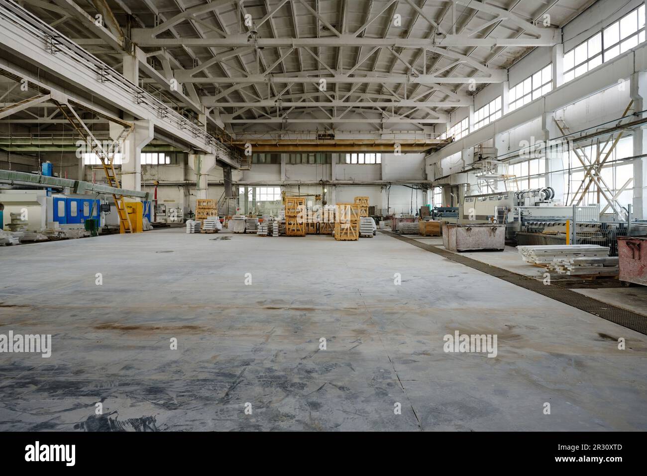 Horizontal image of big empty warehouse with equipment and materials ...