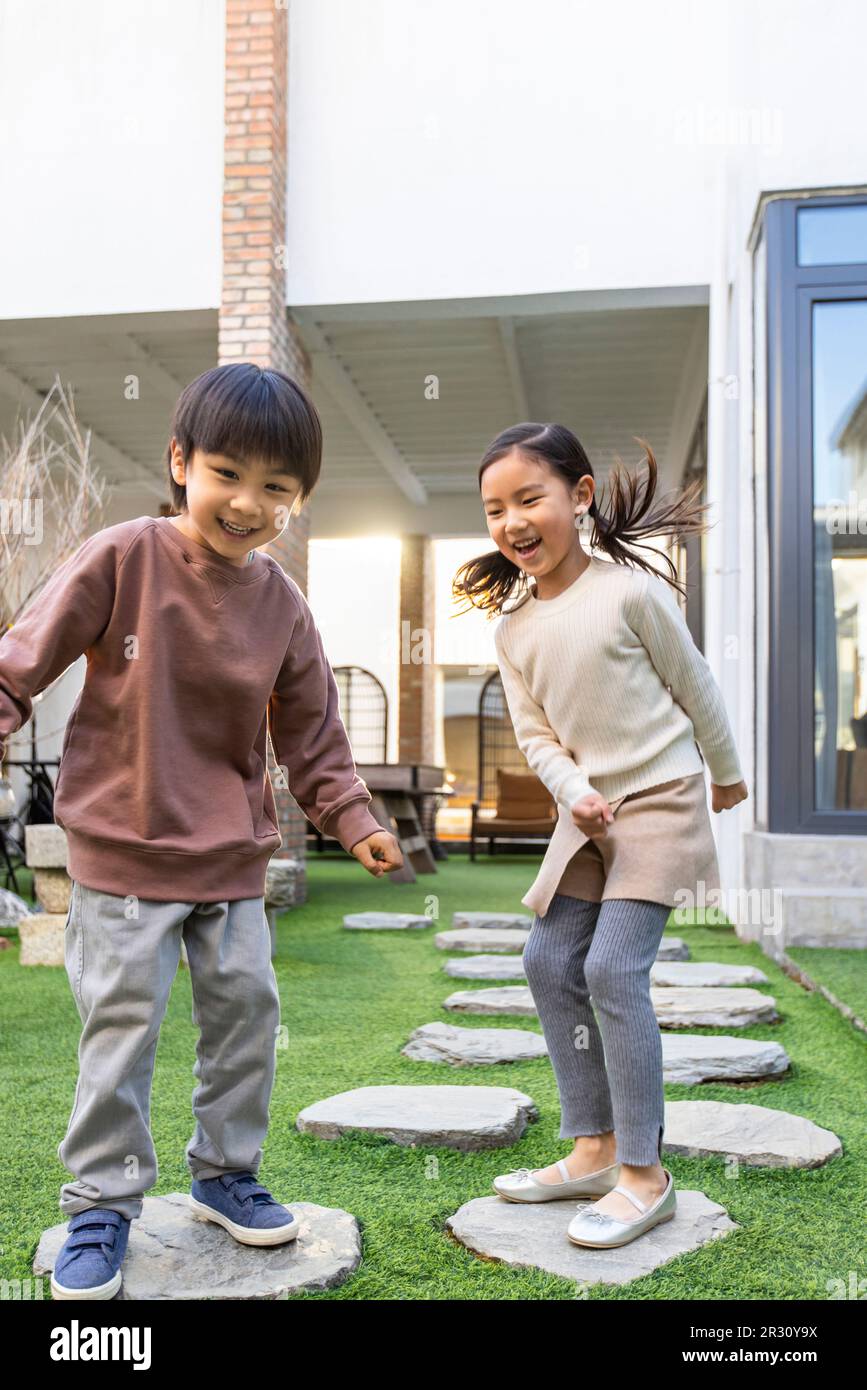 Happy little Chinese children playing in the courtyard Stock Photo - Alamy