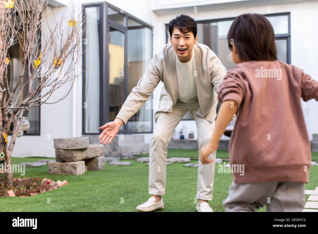 Happy little Chinese boy and his father playing in the courtyard Stock ...