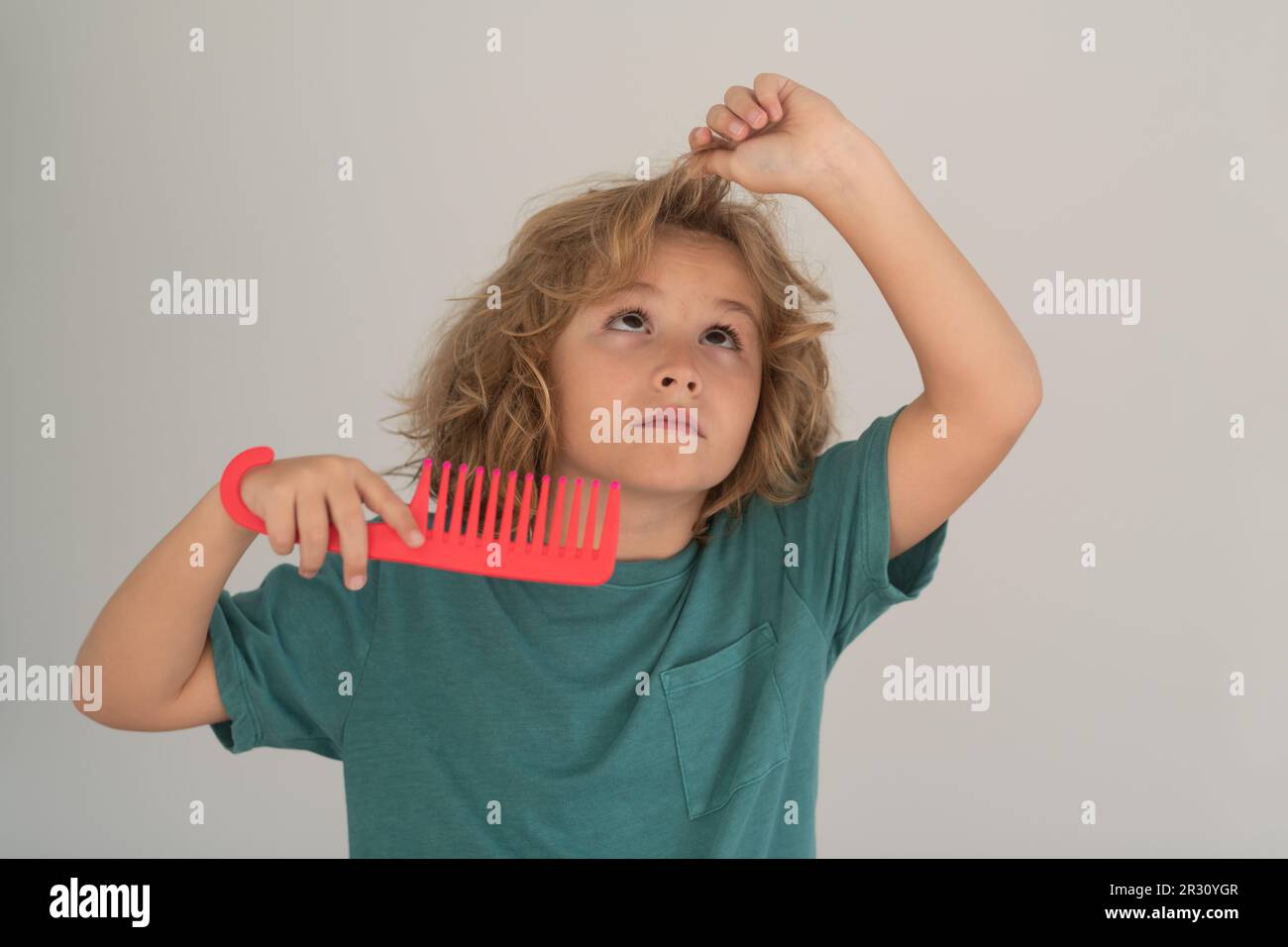 Funny hairstyle. Kid brushing tangled hair. Funny kids haircut Stock ...