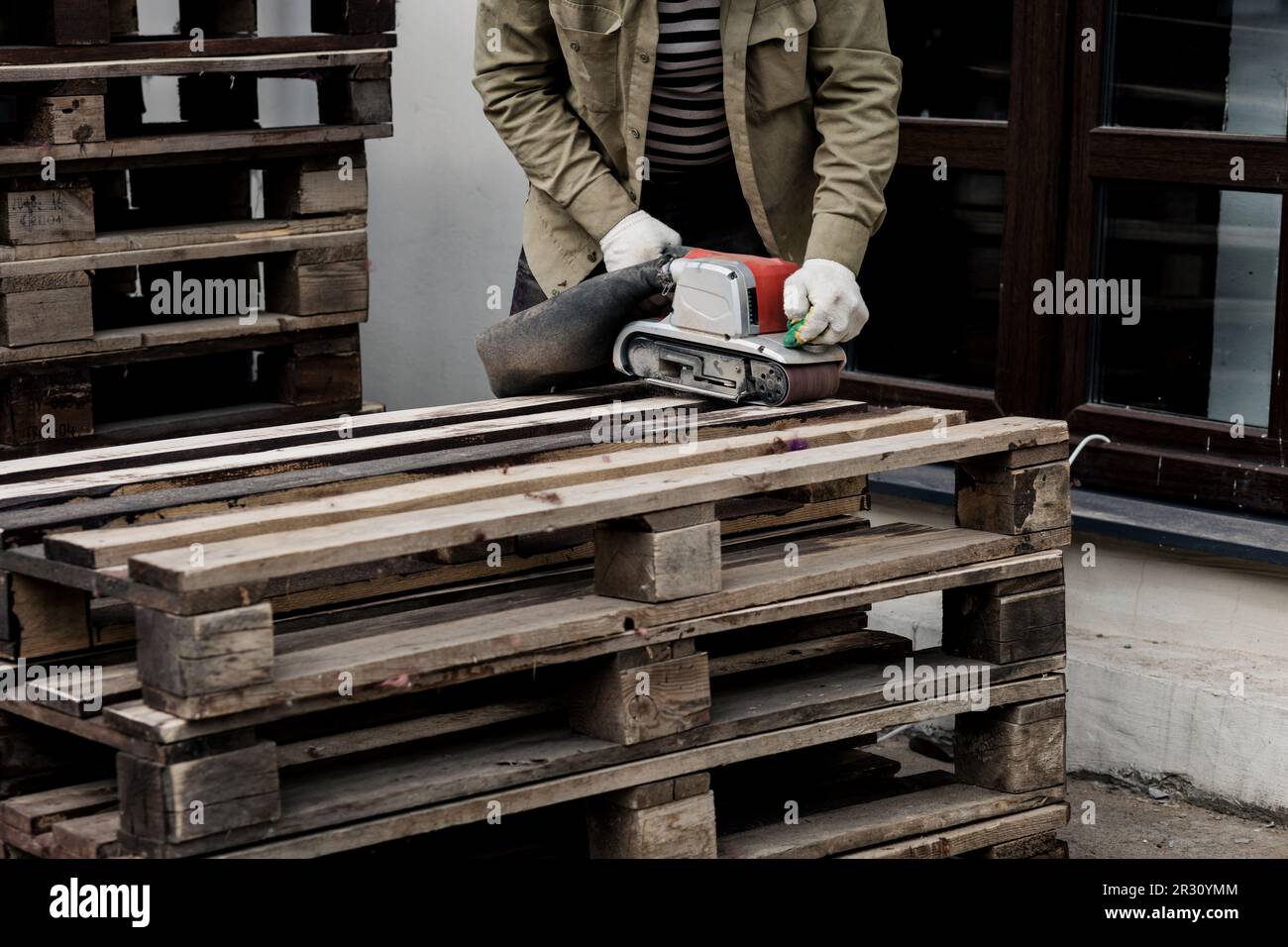 Wood sanding process by using handheld electric belt sander. machine ...