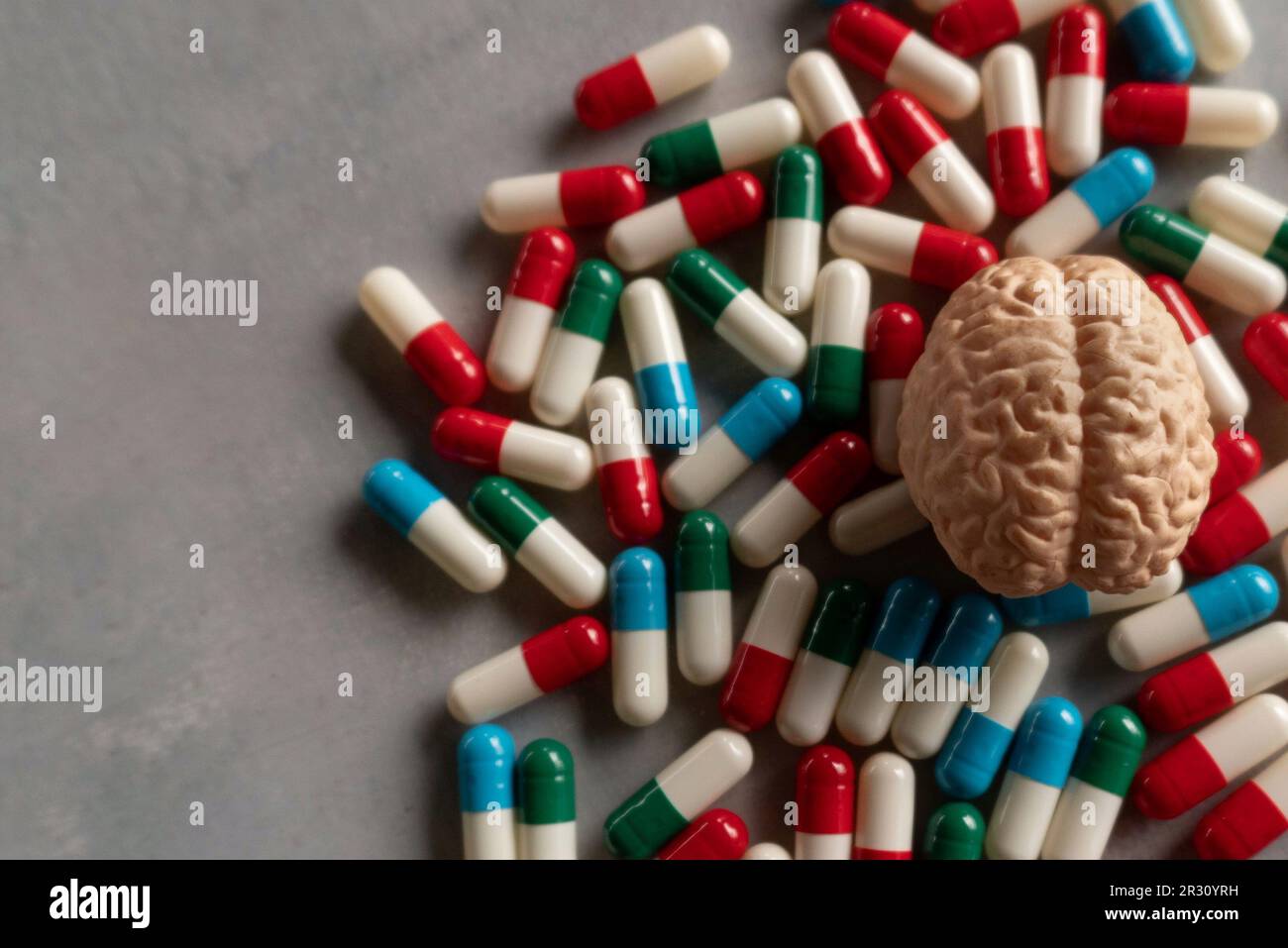 Colorful pills and brain with copy space for text. Mental illness ...