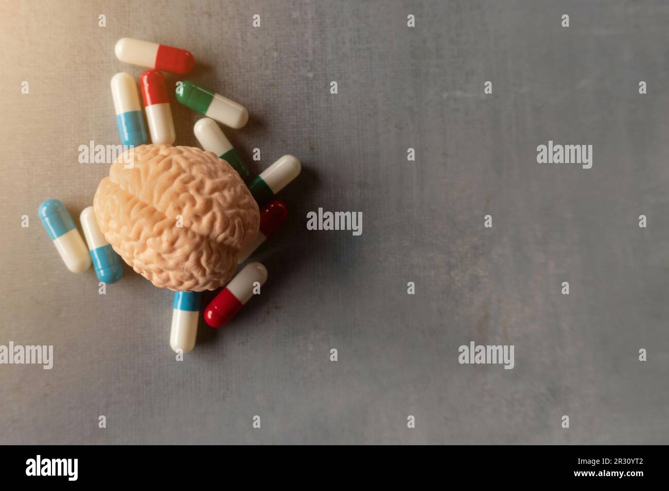 Colorful pills and brain with copy space for text. Mental illness ...