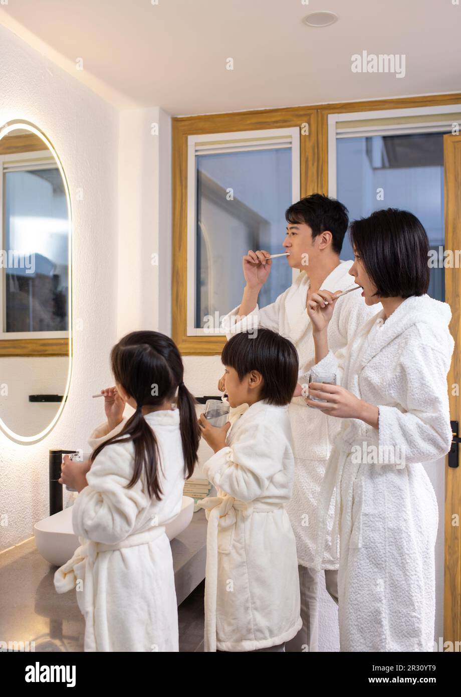 Happy young Chinese family brushing teeth Stock Photo - Alamy