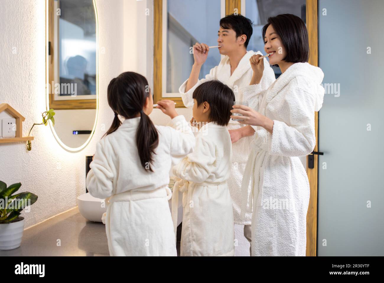 Happy young Chinese family brushing teeth Stock Photo - Alamy