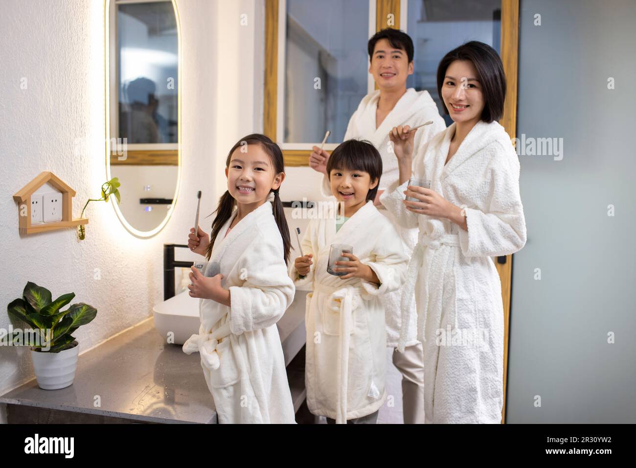 Happy young Chinese family brushing teeth Stock Photo - Alamy