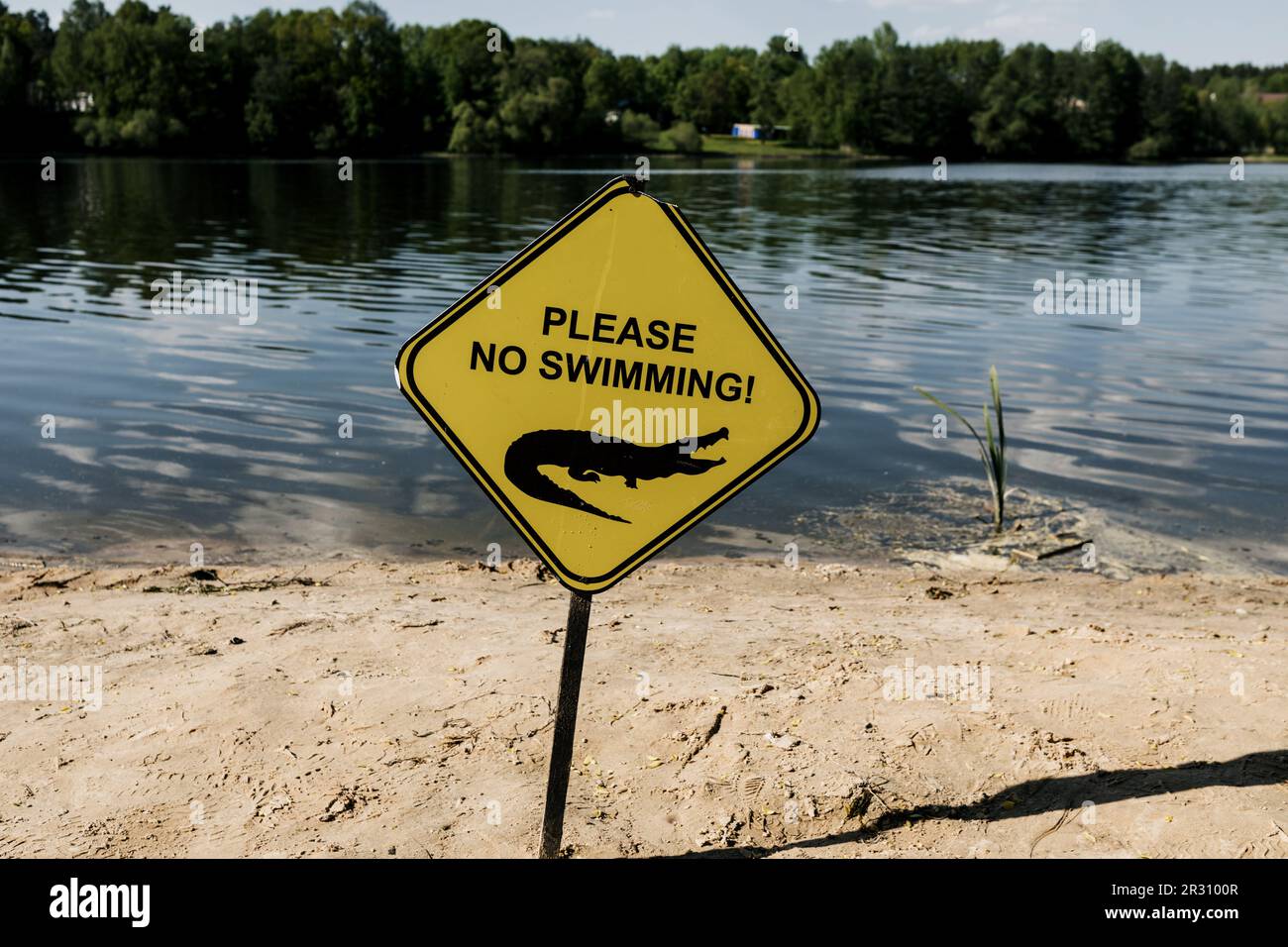 No swimming sign against the waves of lake. careful crocodiles Stock ...