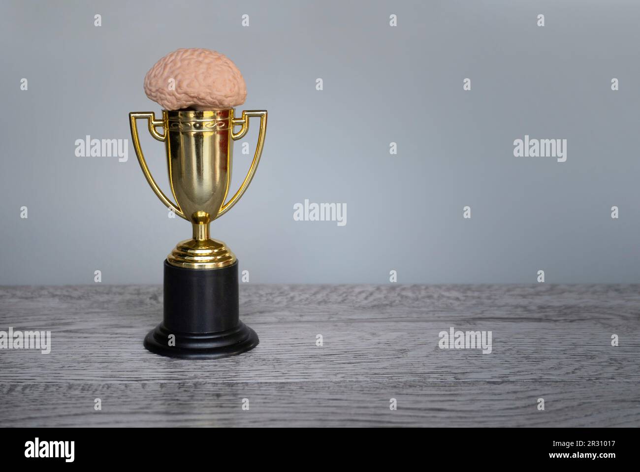 Brain inside gold cup trophy with copy space. Winning mentality and ...