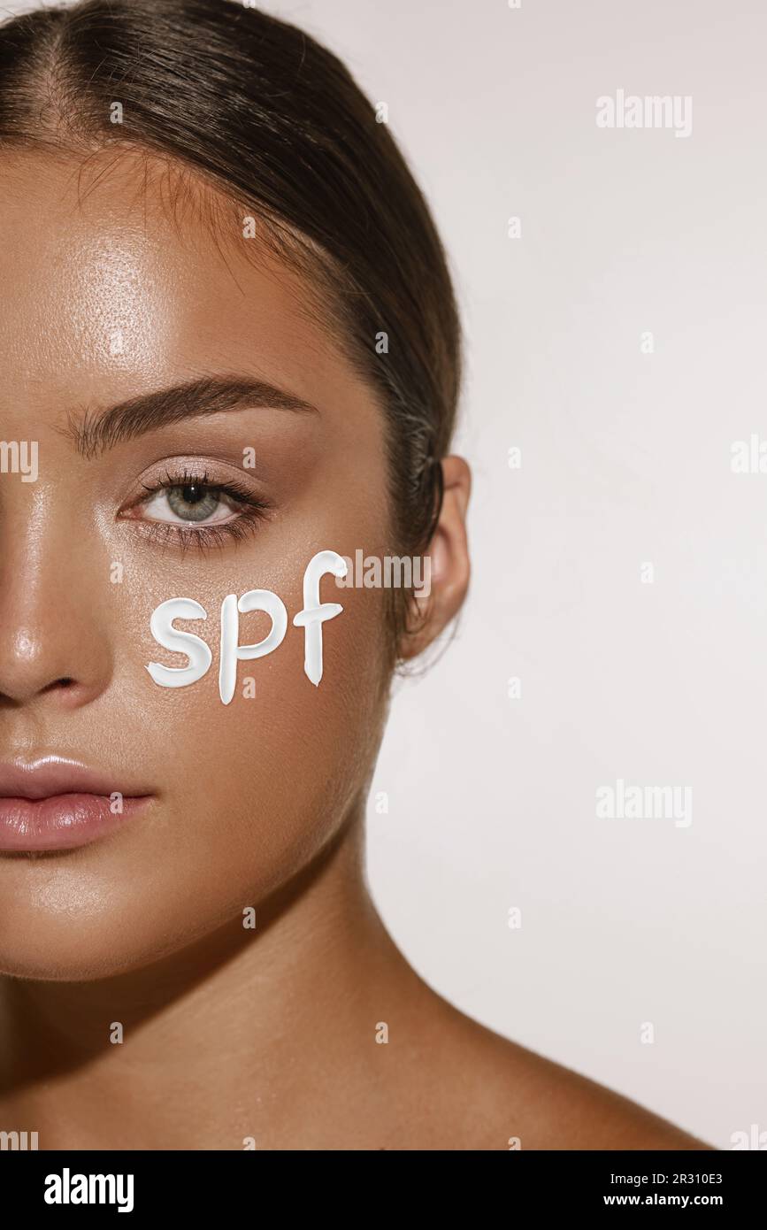 Cropped image of beautiful, glowing female face with tanned skin and ...