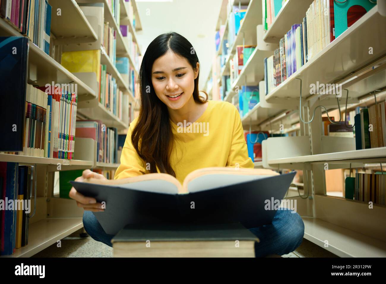 Education, learning, knowledge concept. Smiling female student sitting ...