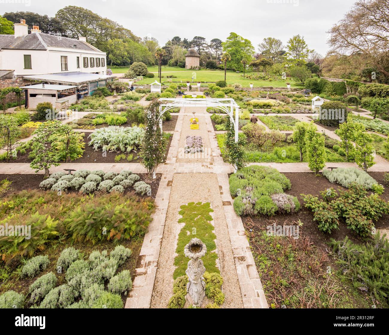 The long view towards the ancient, thatched, Colombier at Samares Manor ...