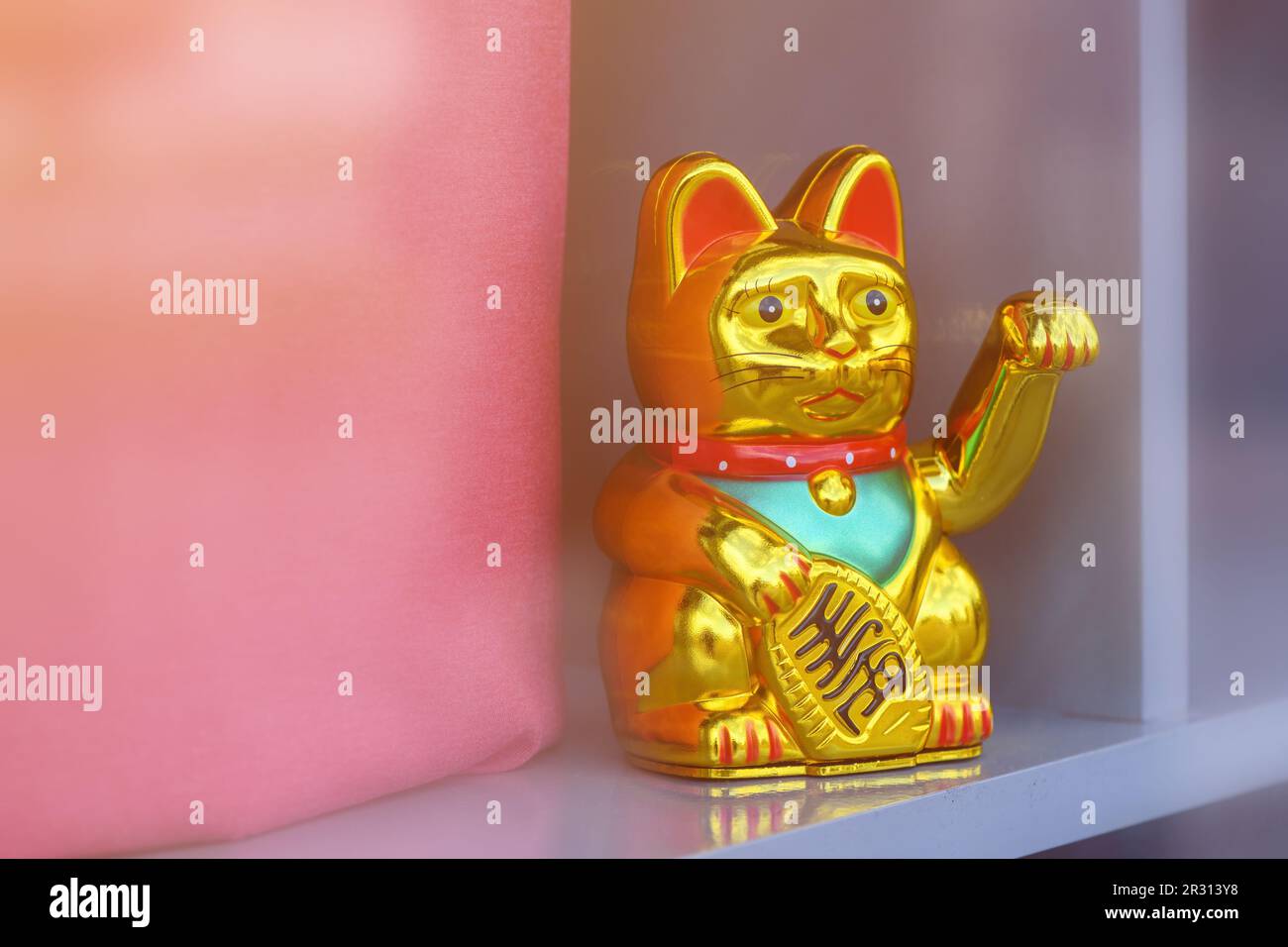 Maneki neko, japanese waving cat adorning the storefront of a trendy ...