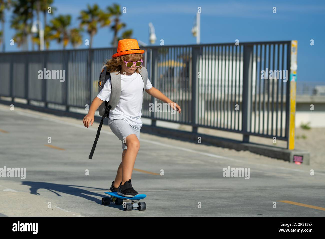 Kid skating on skateboard. Child skateboarding at park in the city. Kid ...