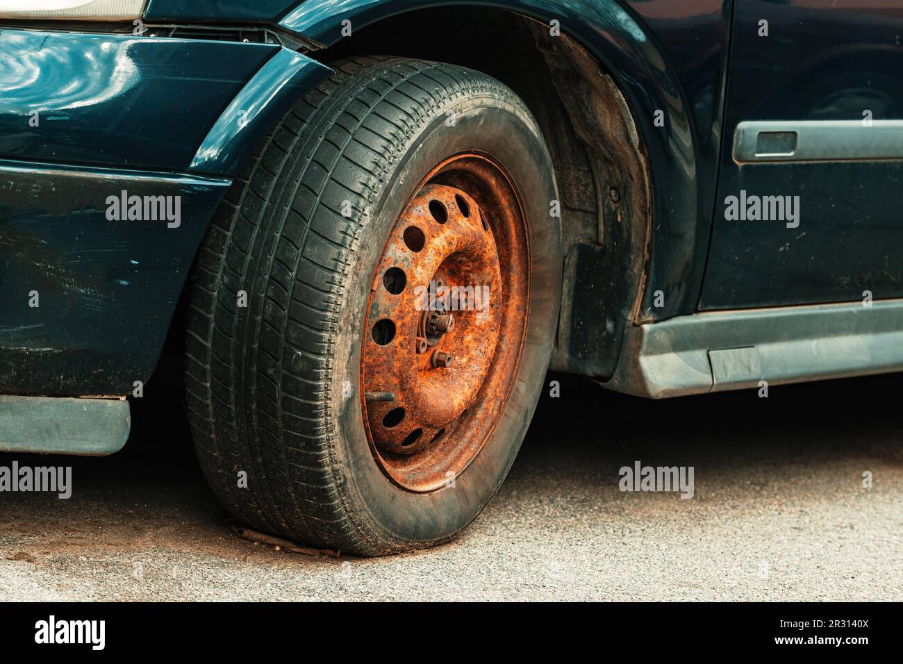 Old rusty car wheel rim and worn tire, selective focus Stock Photo - Alamy