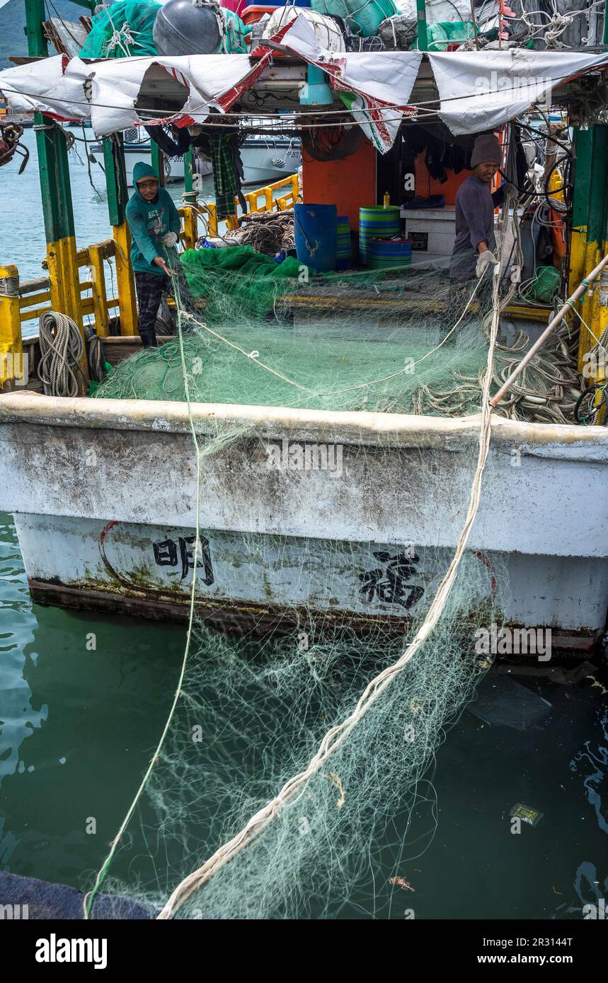 Taipei. 22nd May, 2023. Fishermen hoist fishing nets onto fishing ...