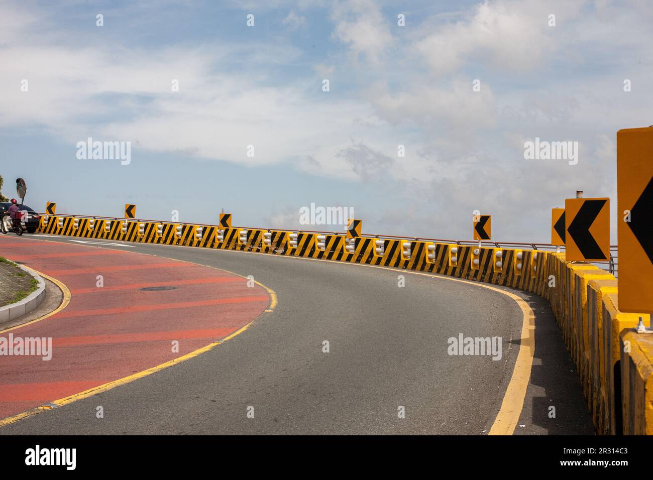 a curved road and signboard Stock Photo - Alamy