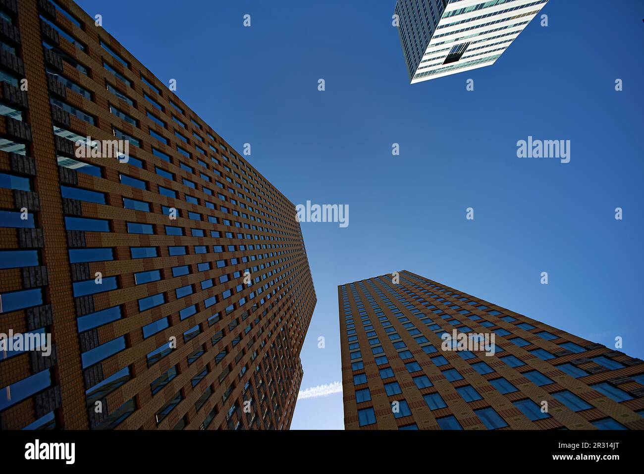 Looking up at high rise skyscrapers office towers in bright sunshine ...