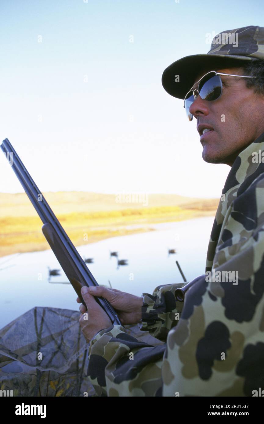Portrait of a duck hunter with shotgun Stock Photo - Alamy