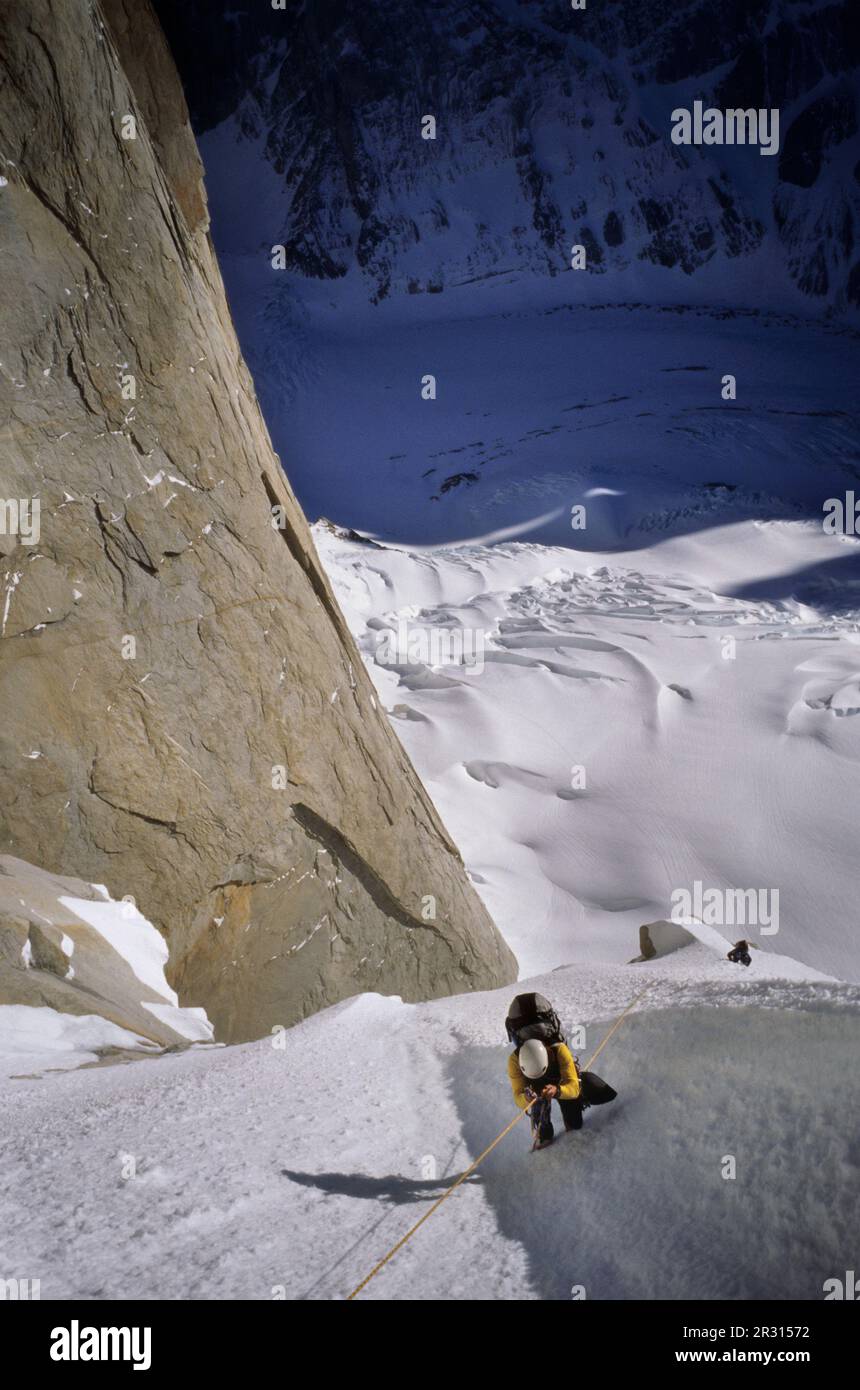 A climber ascends a rope on Cerro Torre's east face with the Torre ...