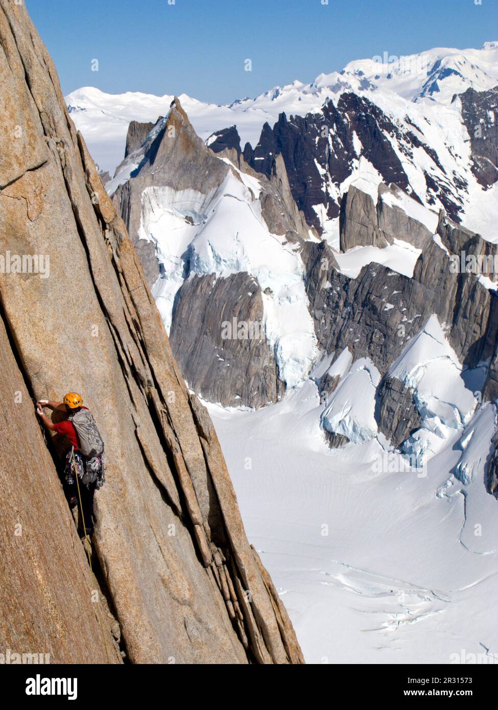 A climber ascends a crack in smooth granite on the north pillar of ...