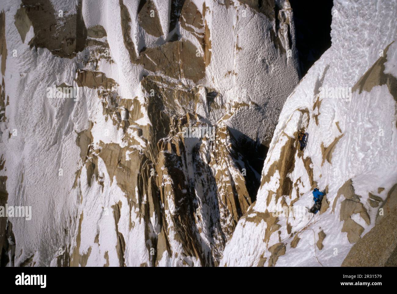 A mountaineer climbs the northwest face of Cerro Torre, with Torre ...