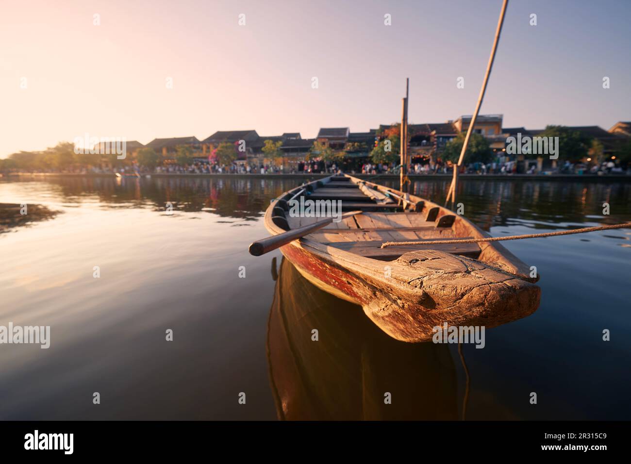 Close-up wooden boat moored against busy waterfront ancient city Hoi An ...