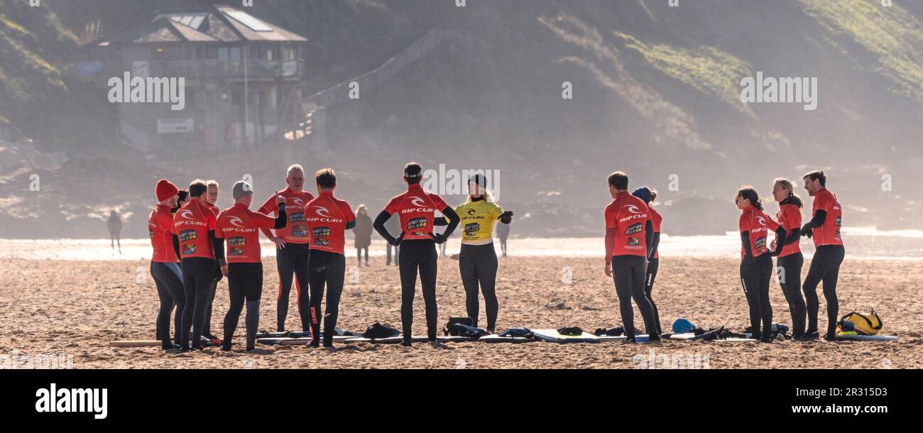 A panoramic image of a group of body boarders listening to an ...