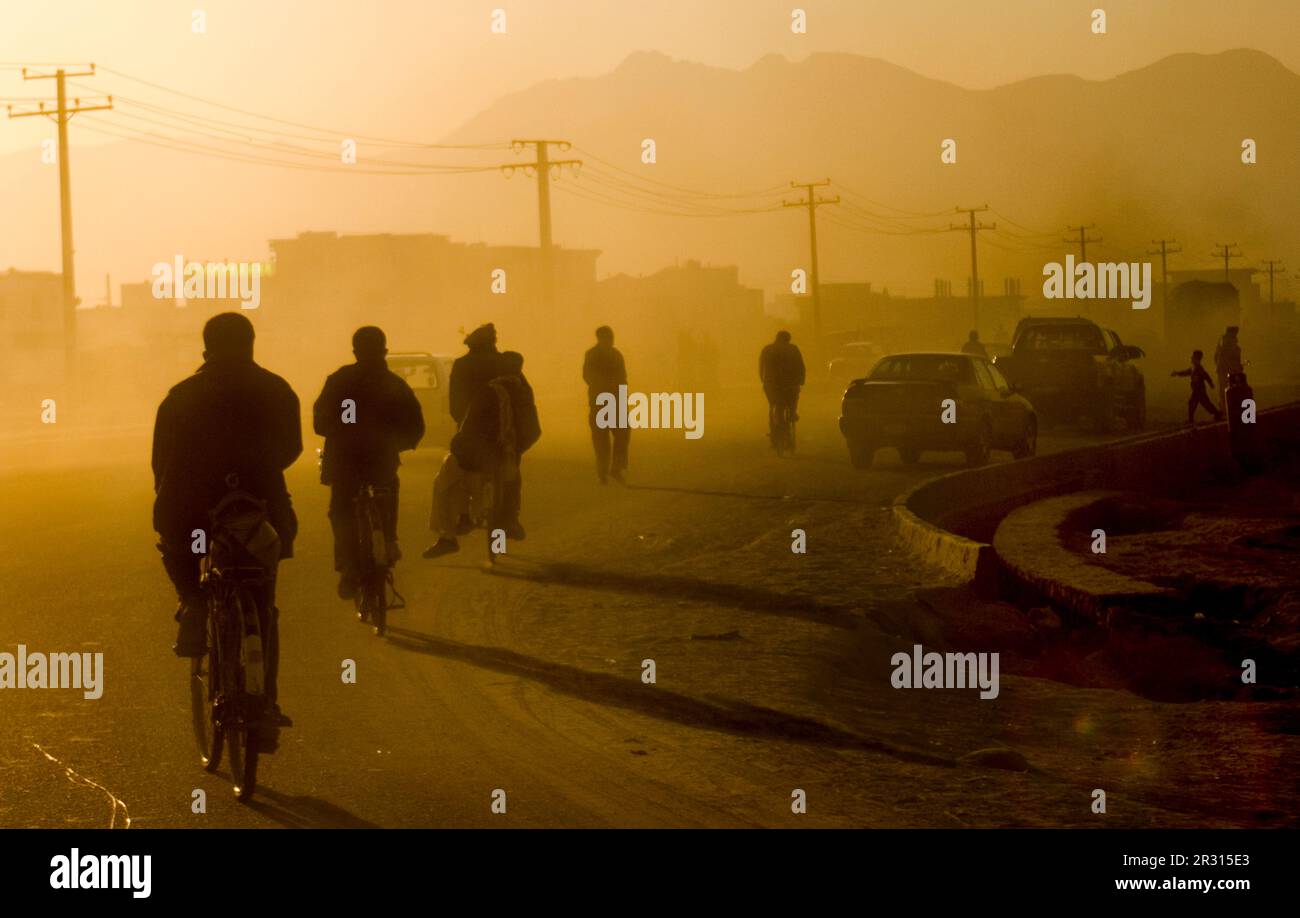 Bikes, pedestrians and all manner of vehicles create a dust cloud ...