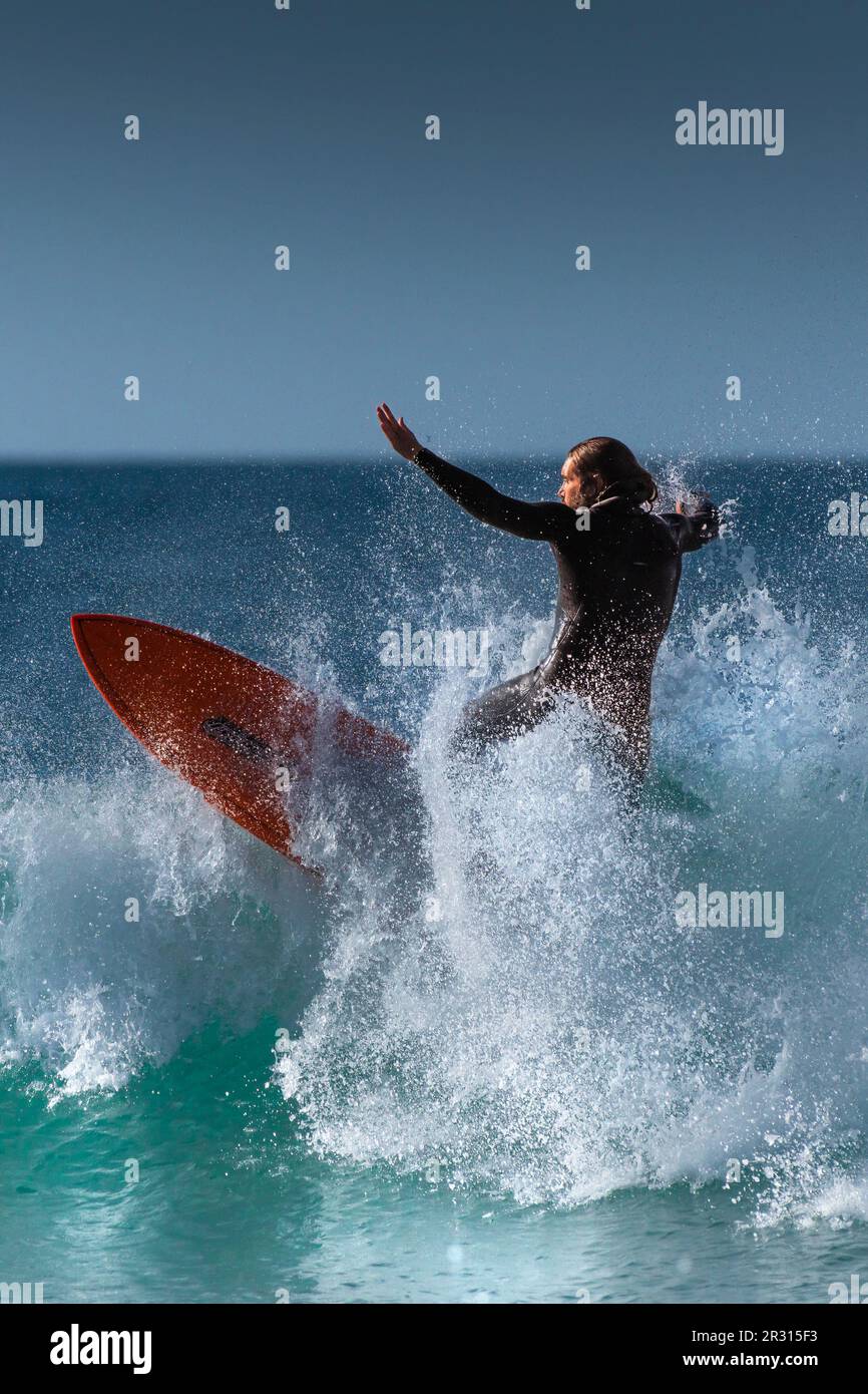 Spectaular surfing action as a male surfer rides a wave at Fistral in ...