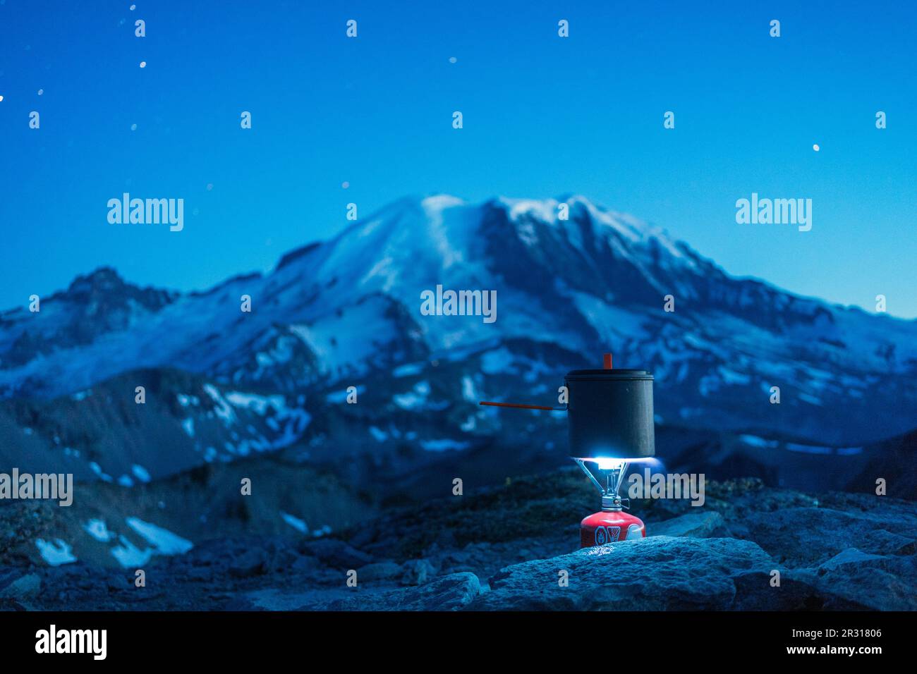 Cooking dinner on a small burner while backpacking in Washington Stock ...