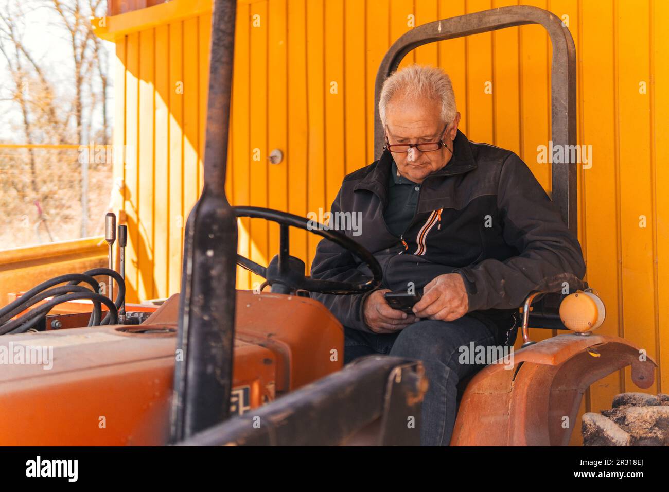 older man from modern countryside working with mobile Stock Photo - Alamy