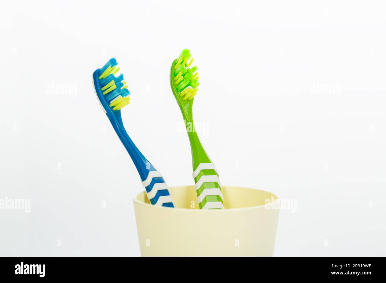 Toothbrush in a plastic cup on white background. Oral hygiene Stock ...