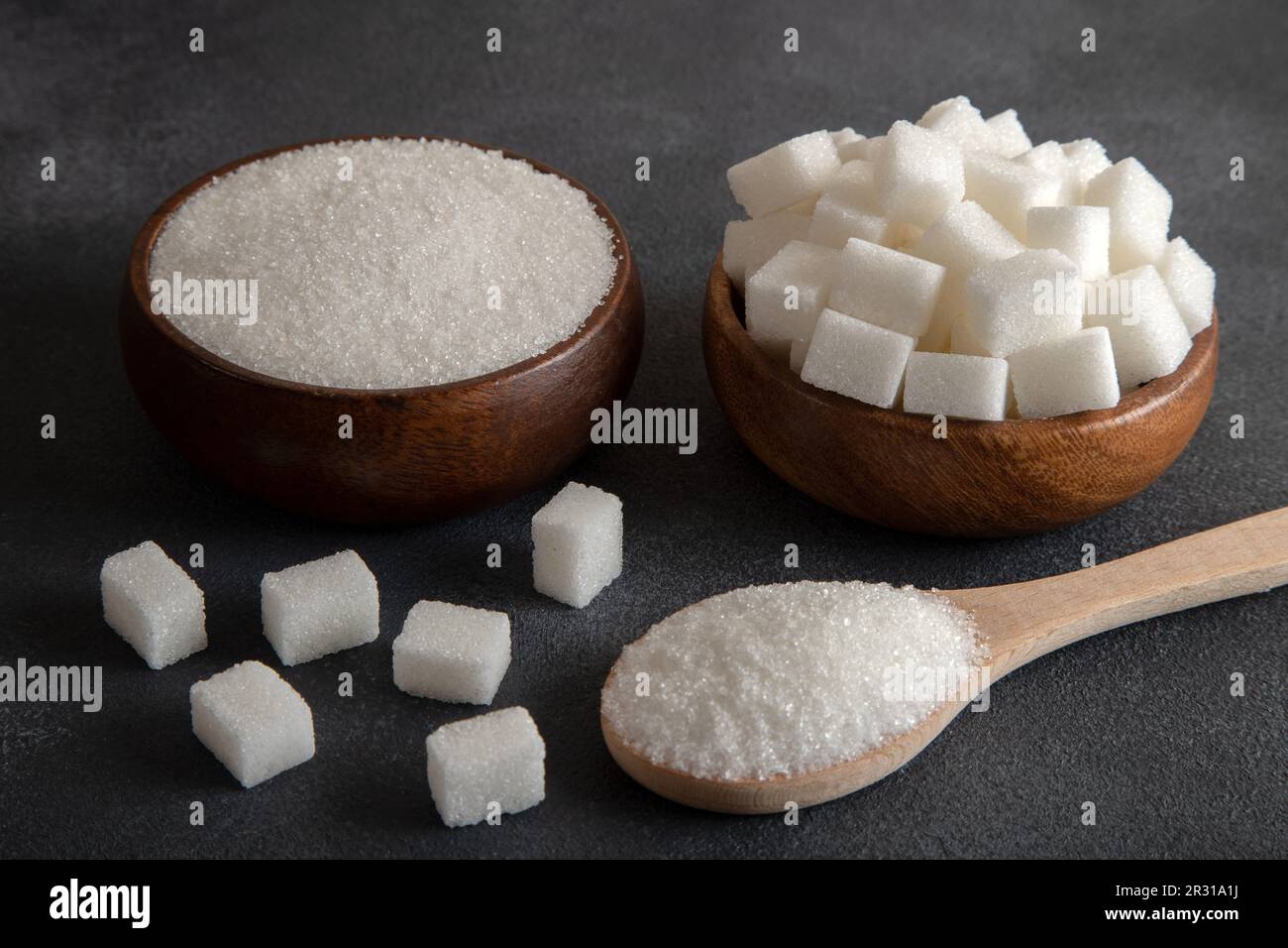 Cube sugar and granulated sugar on black background,closeup Stock Photo ...