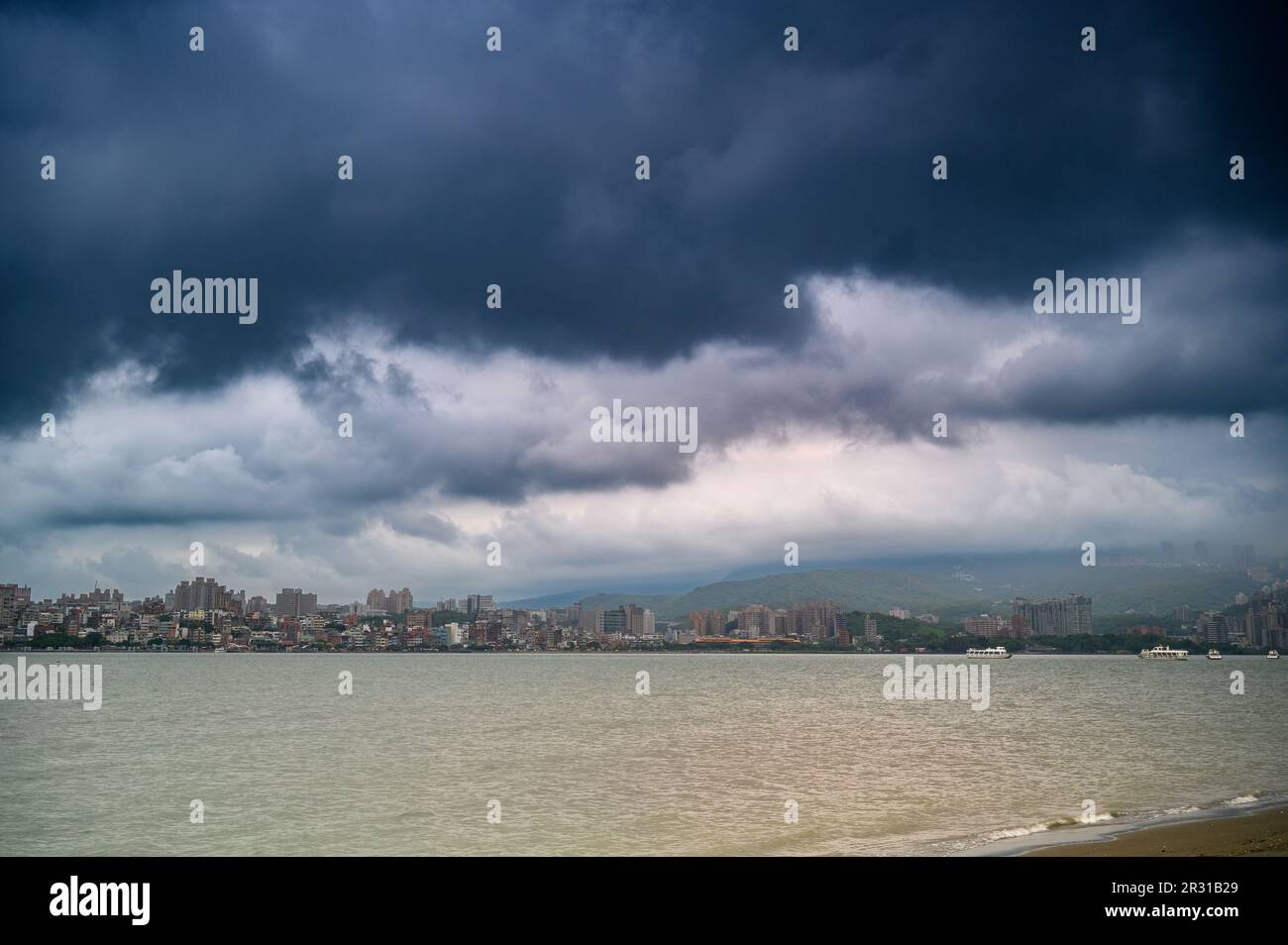 On cloudy days, there are fast moving clouds over the Tamsui River. The ...