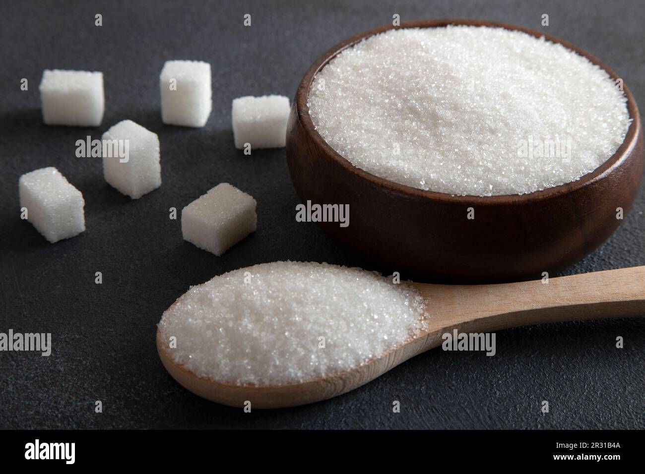 Cube sugar and granulated sugar on black background,closeup Stock Photo ...