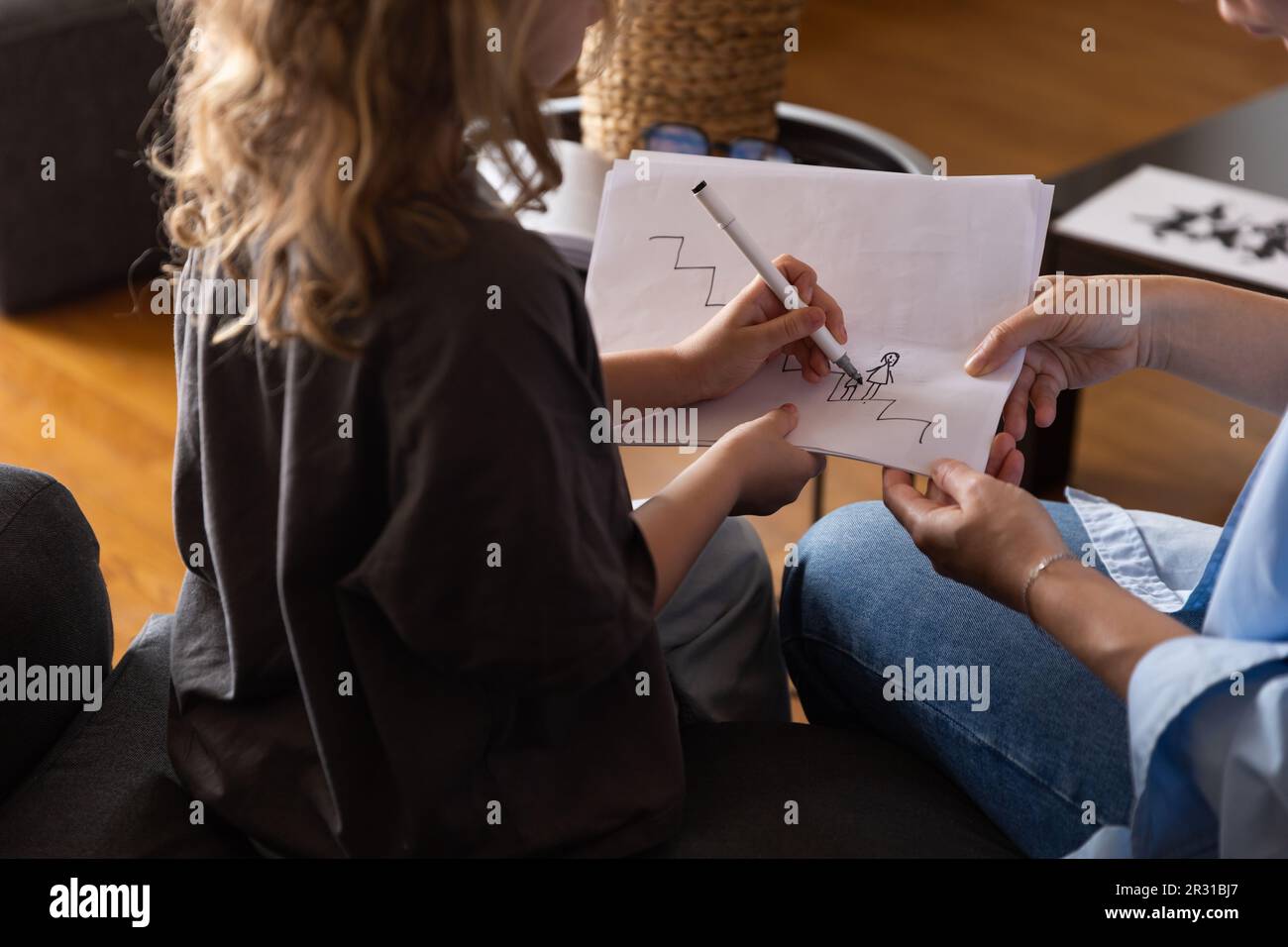 A girl at a psychologist's appointment draws a test drawing, low self ...