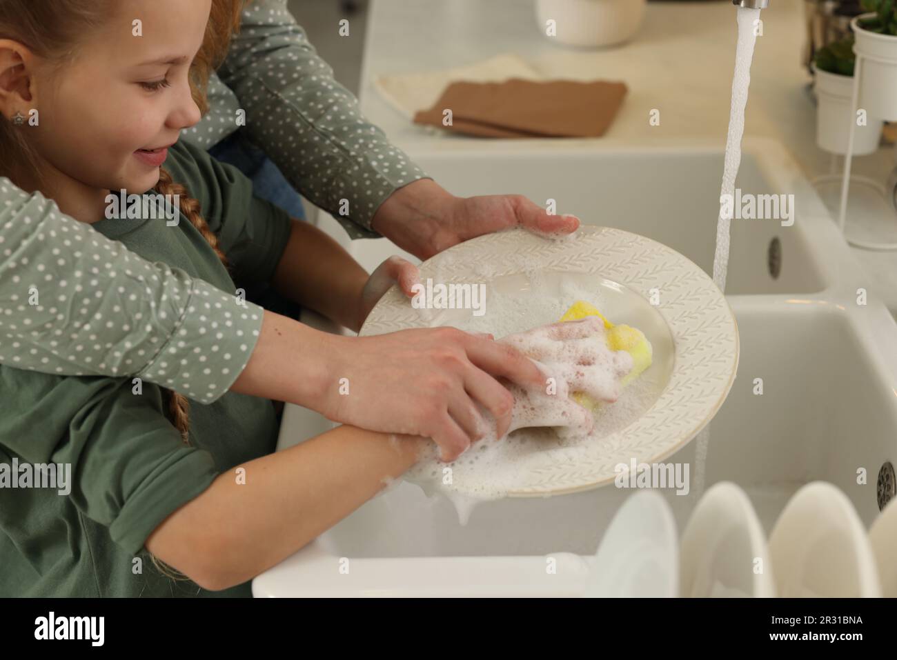 Child washing hands with help hi-res stock photography and images - Alamy