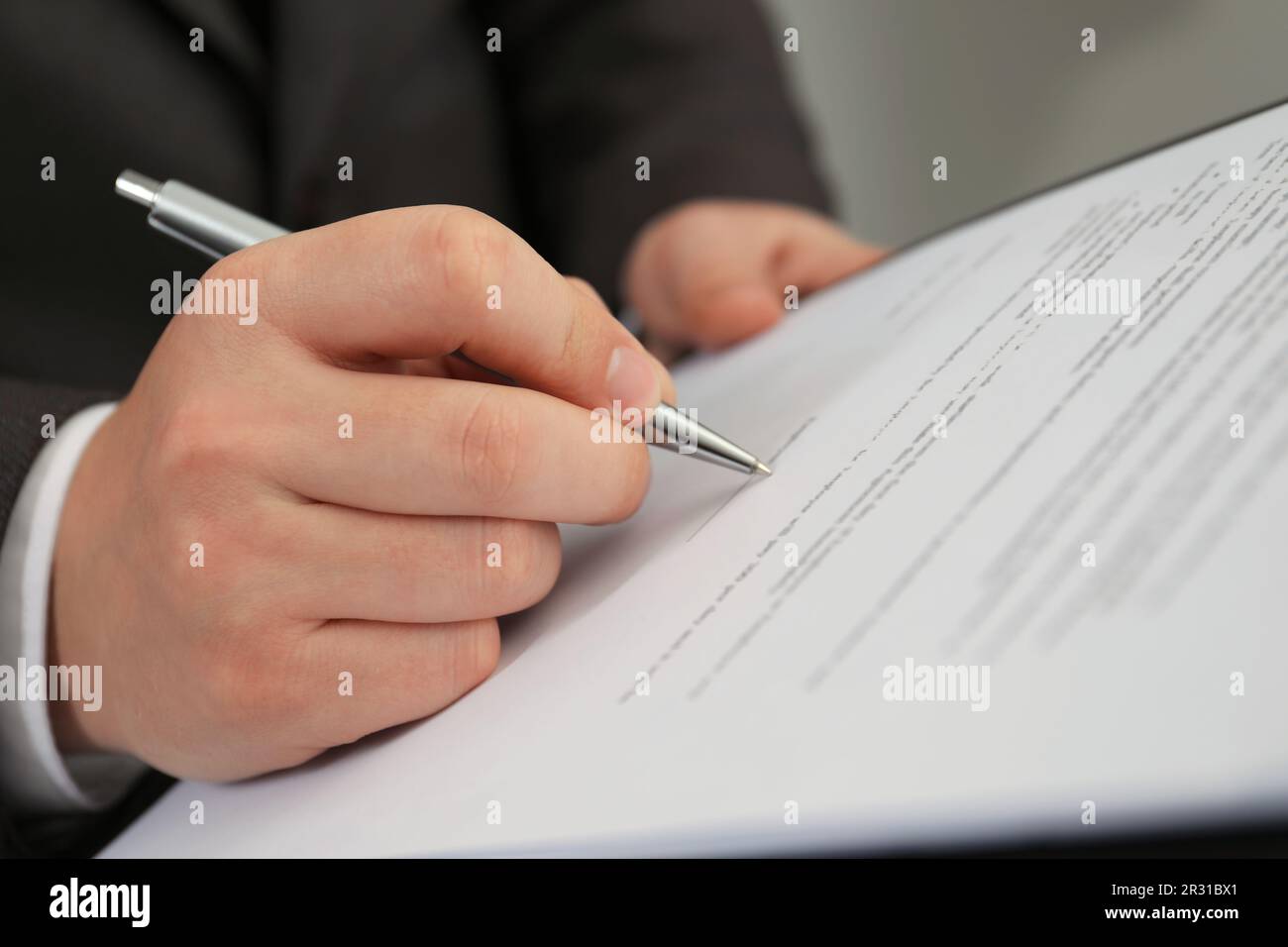 Man signing document at table in office, closeup Stock Photo - Alamy