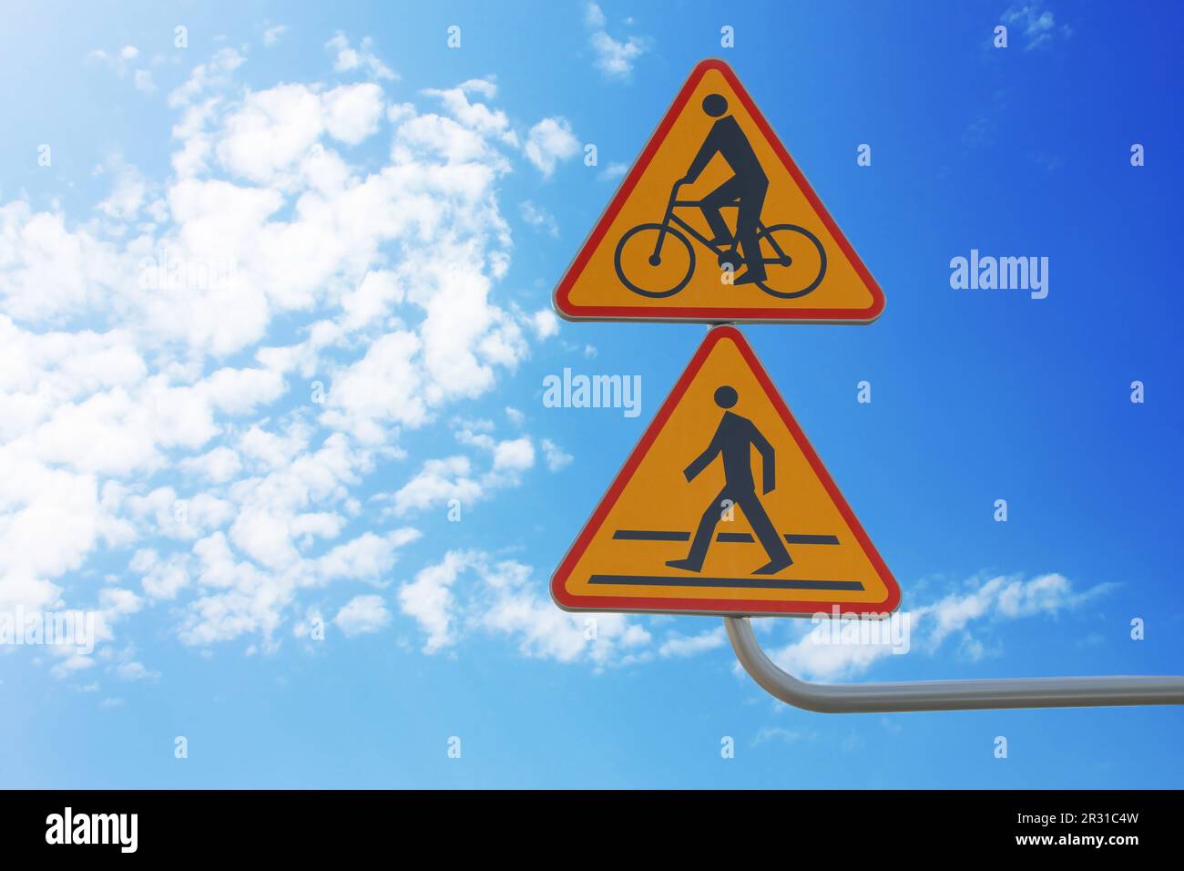 Signpost with Pedestrian Crossing Ahead and Cycle Route against clear ...