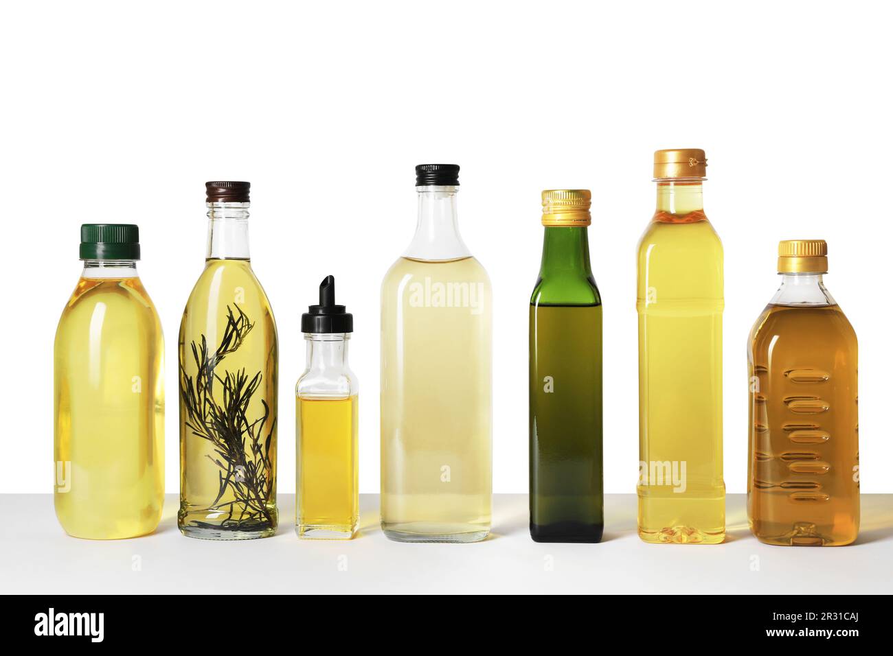 Bottles of different cooking oils on white background Stock Photo - Alamy